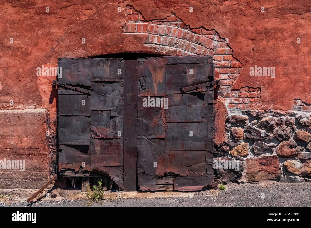 Old brick building with metal door along an alley in Pomeroy ...