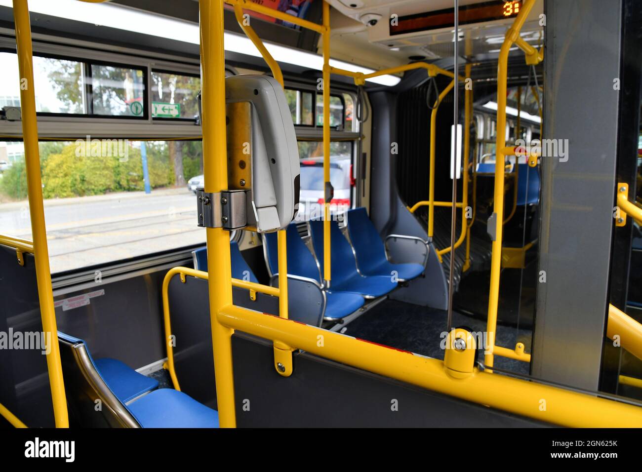 Blue plastic seats and yellow hand rails on SFMTA bus interior; San ...