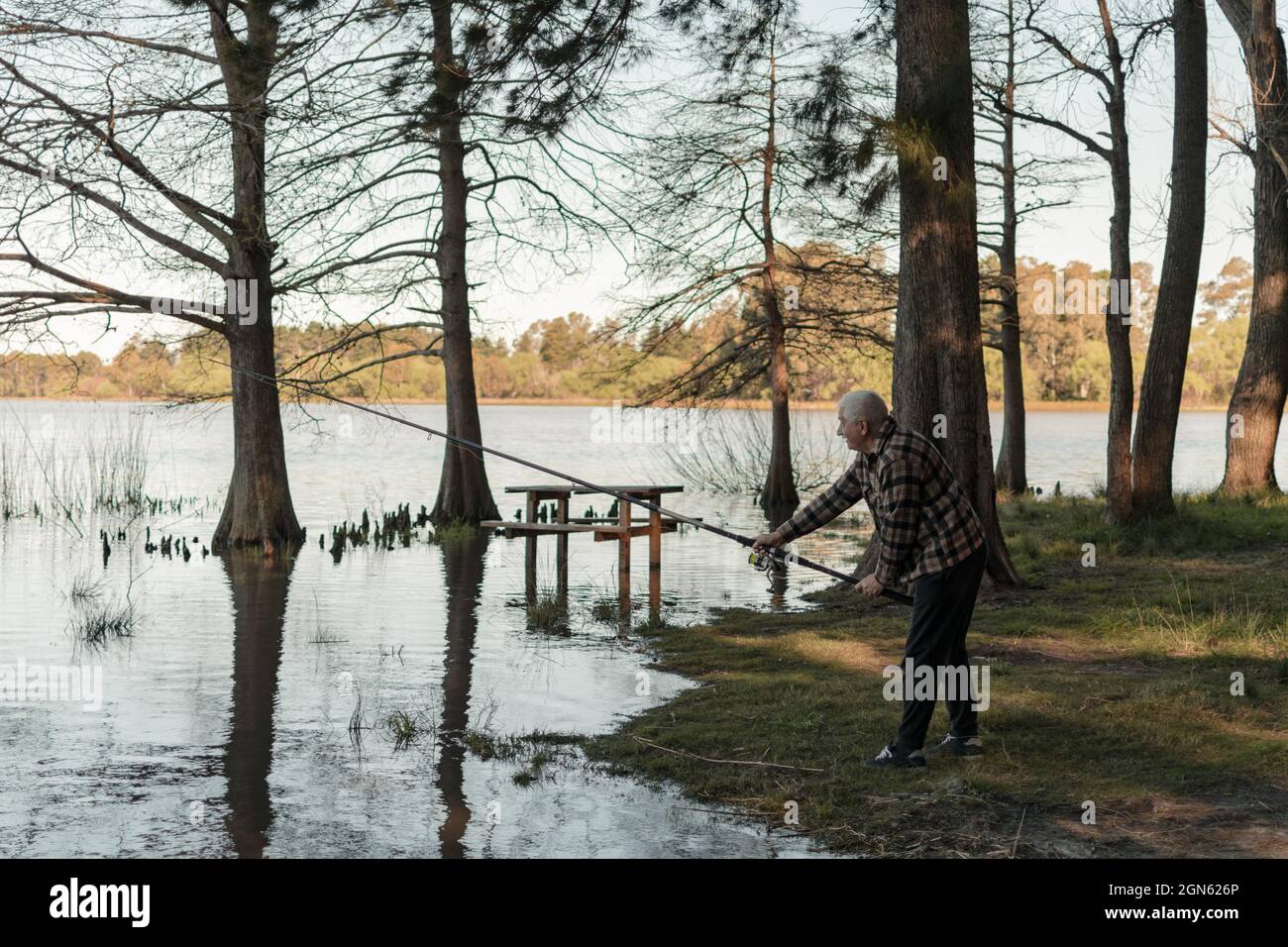 Older Latino at the exact moment after throwing the fishing rod Stock ...