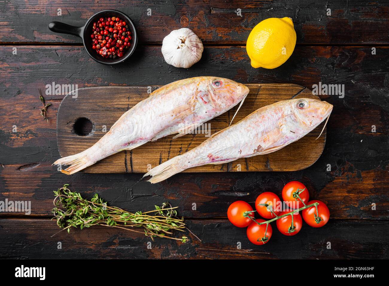 Raw Goatfish fresh whole fish set, with ingredients and herbs, on old ...