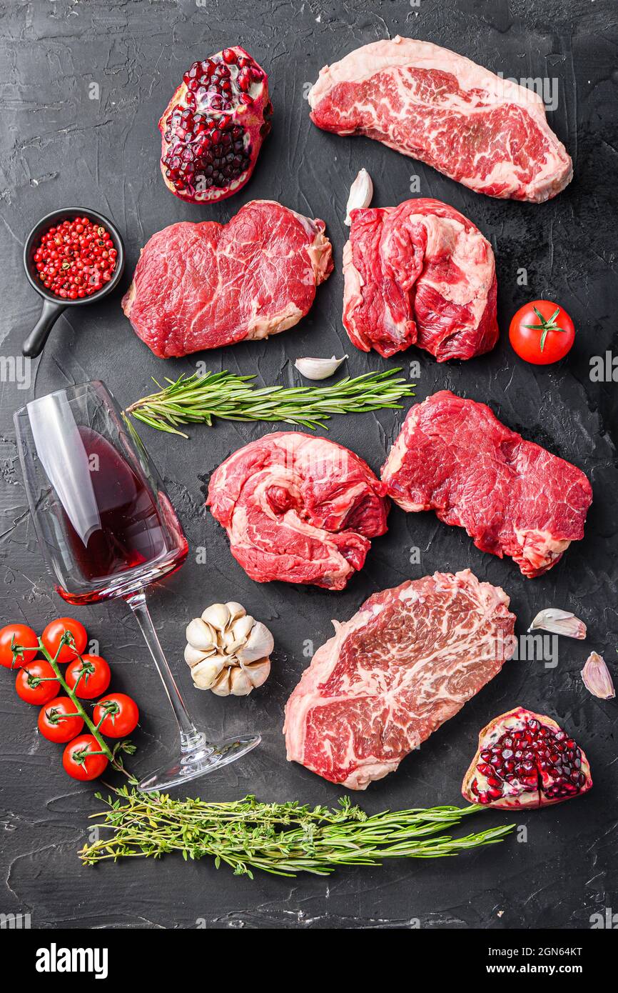 Alternative beef cut set with herbs and red wine glass, top view Stock ...