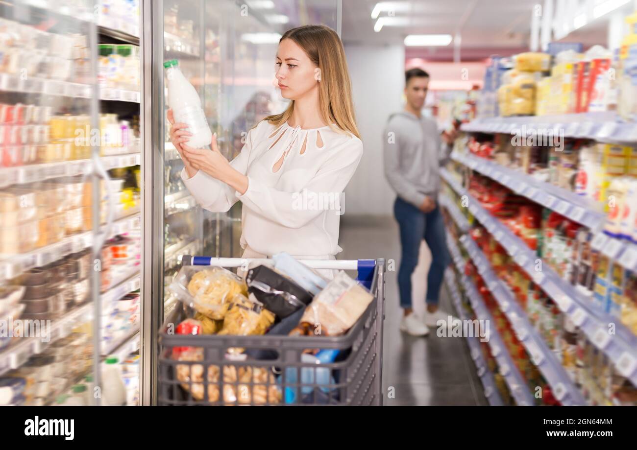 Female consumer buying milk hi-res stock photography and images - Alamy