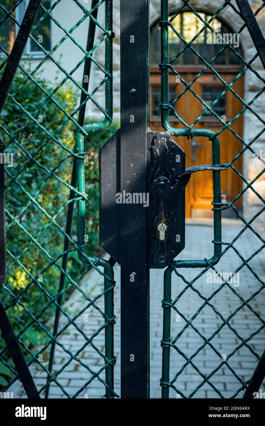 Vertical of an old black painted handle on the metallic door Stock ...