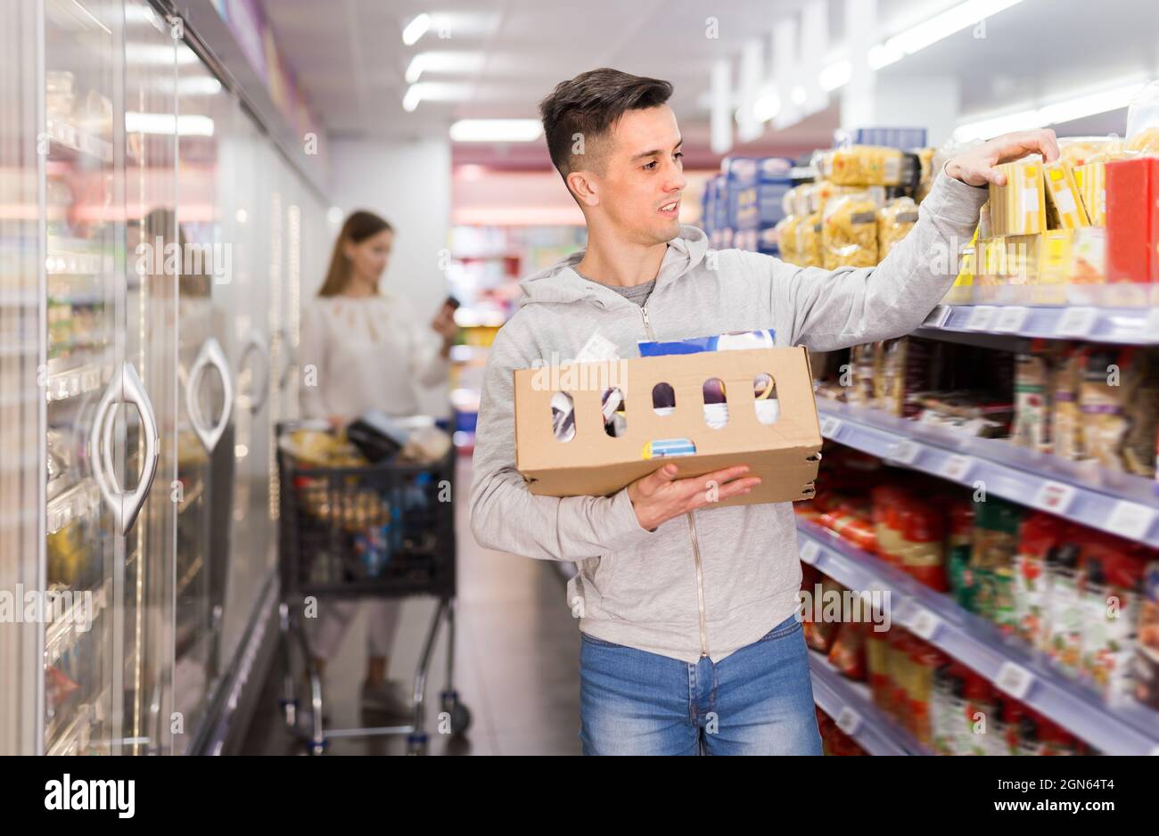 Cheerful male customer with cardboard box Stock Photo - Alamy