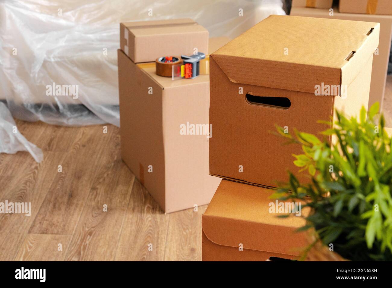 Moving in or moving out concept. Stack of boxes and packed furniture ...