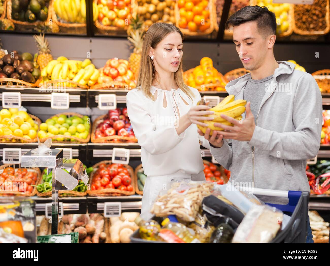 Two customers choosing fruits in grocery Stock Photo - Alamy
