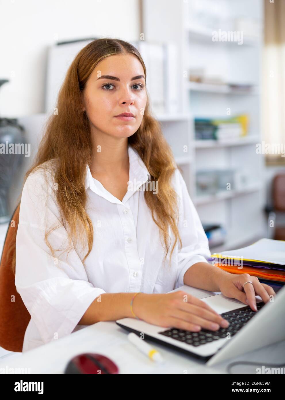 Office worker sitting at desk in office Stock Photo - Alamy
