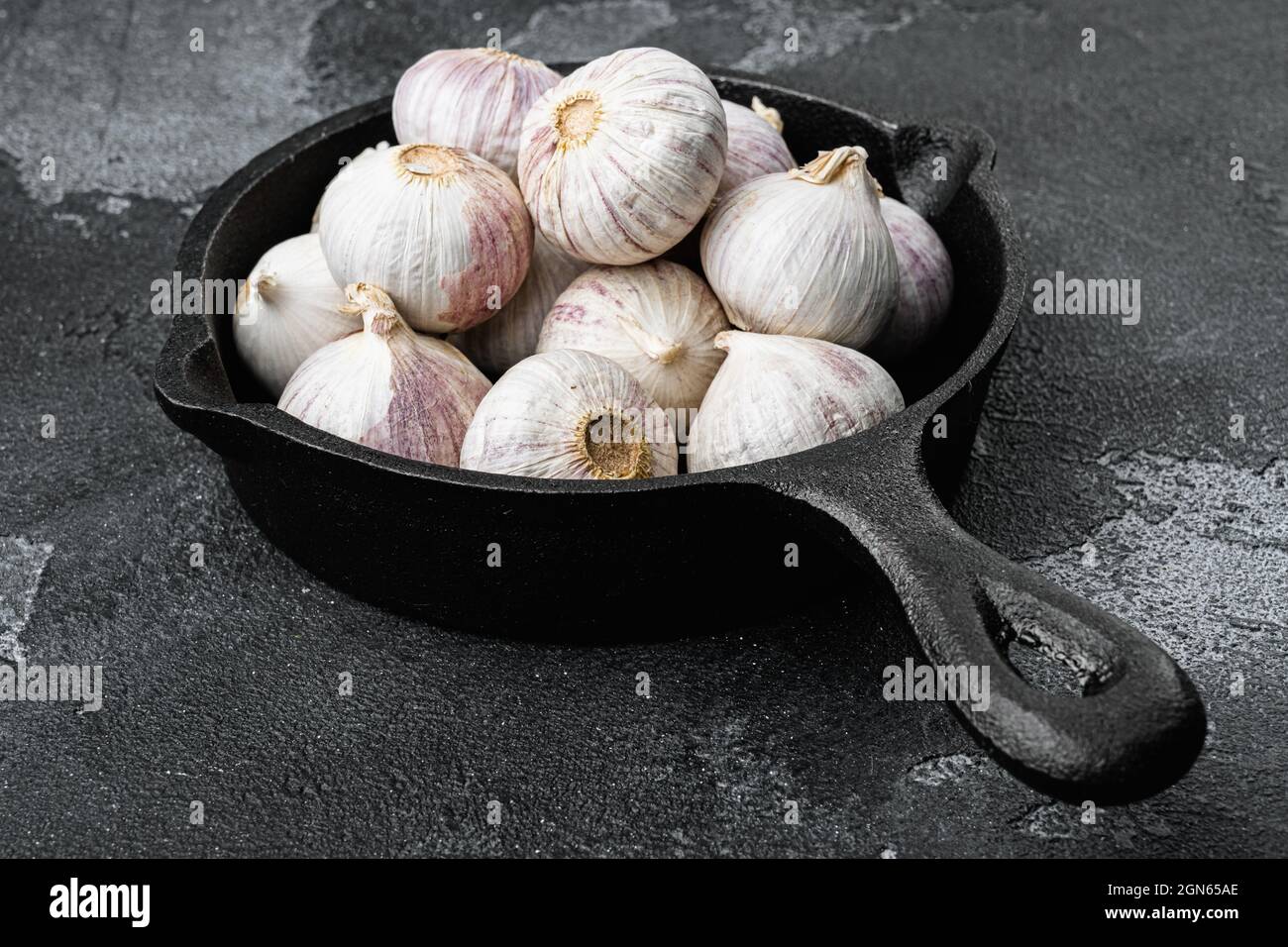 Baby garlic set, on black dark stone table background Stock Photo - Alamy
