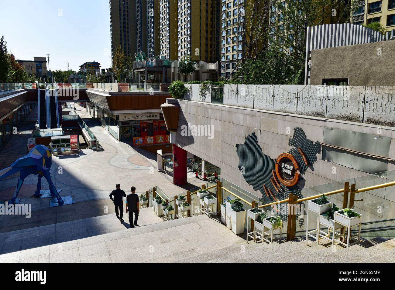 Beijing, China. 22nd Sep, 2021. People pass in front of Evergrande ...