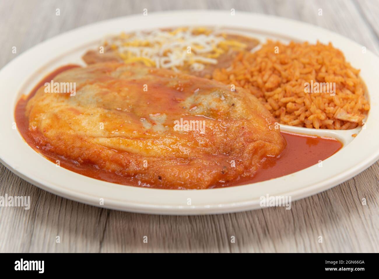 Chili relleno served on a plate with rice, and beans for a very hearty ...