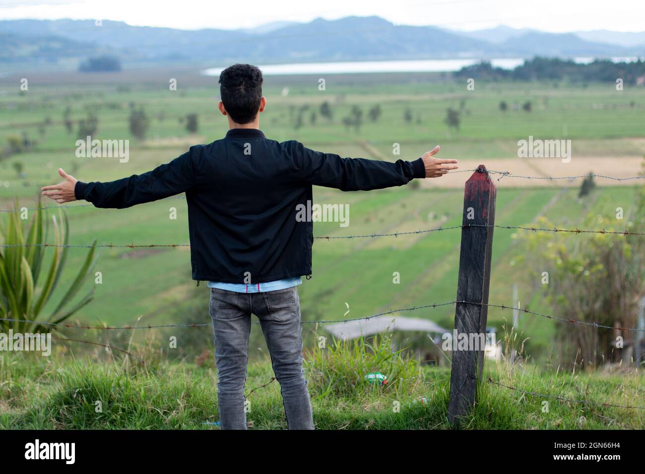 Man watching beautiful scenery with meadows and lake of fuquene Stock ...