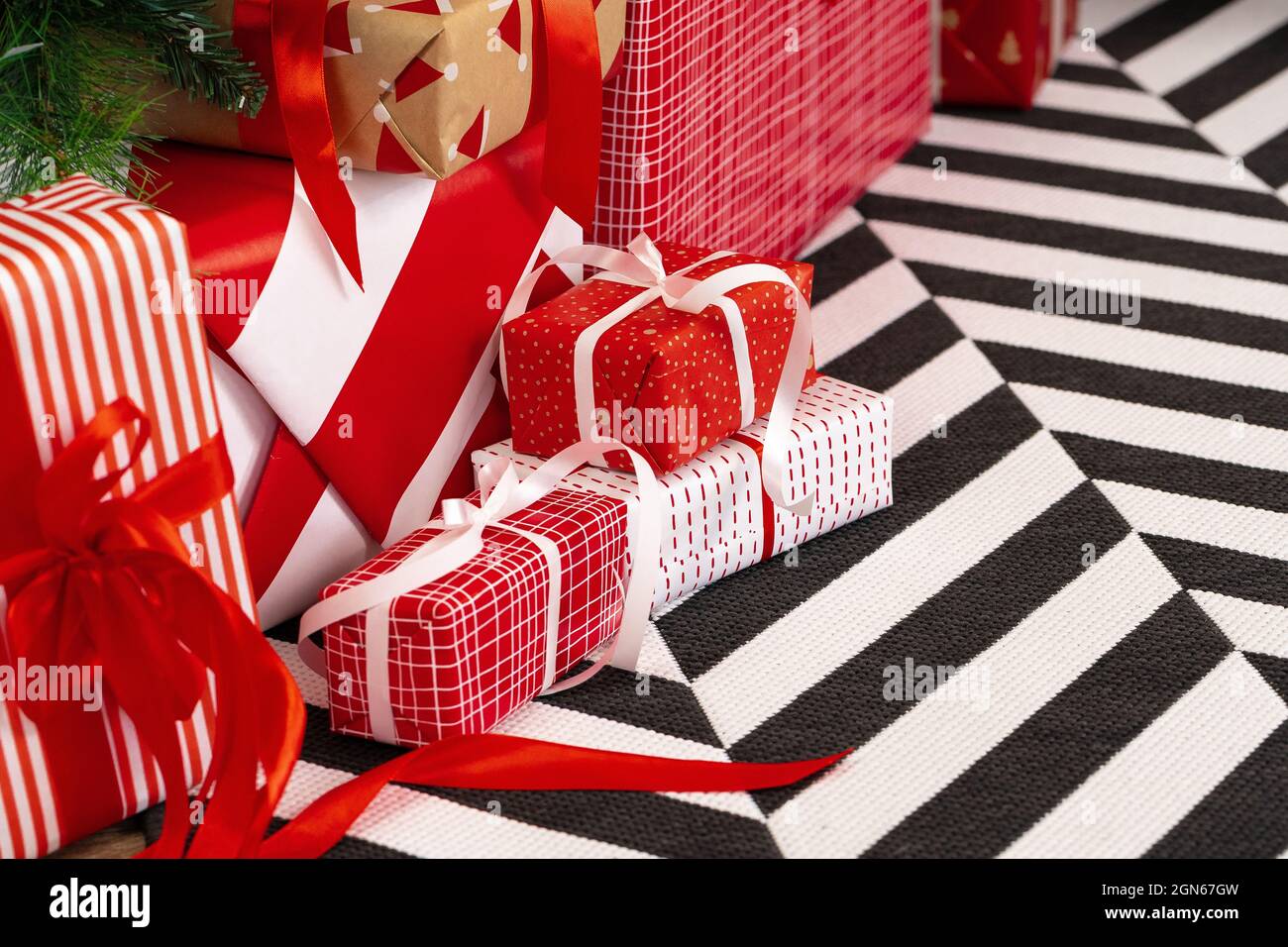 Pile of wrapped presents under the Christmas tree Stock Photo - Alamy