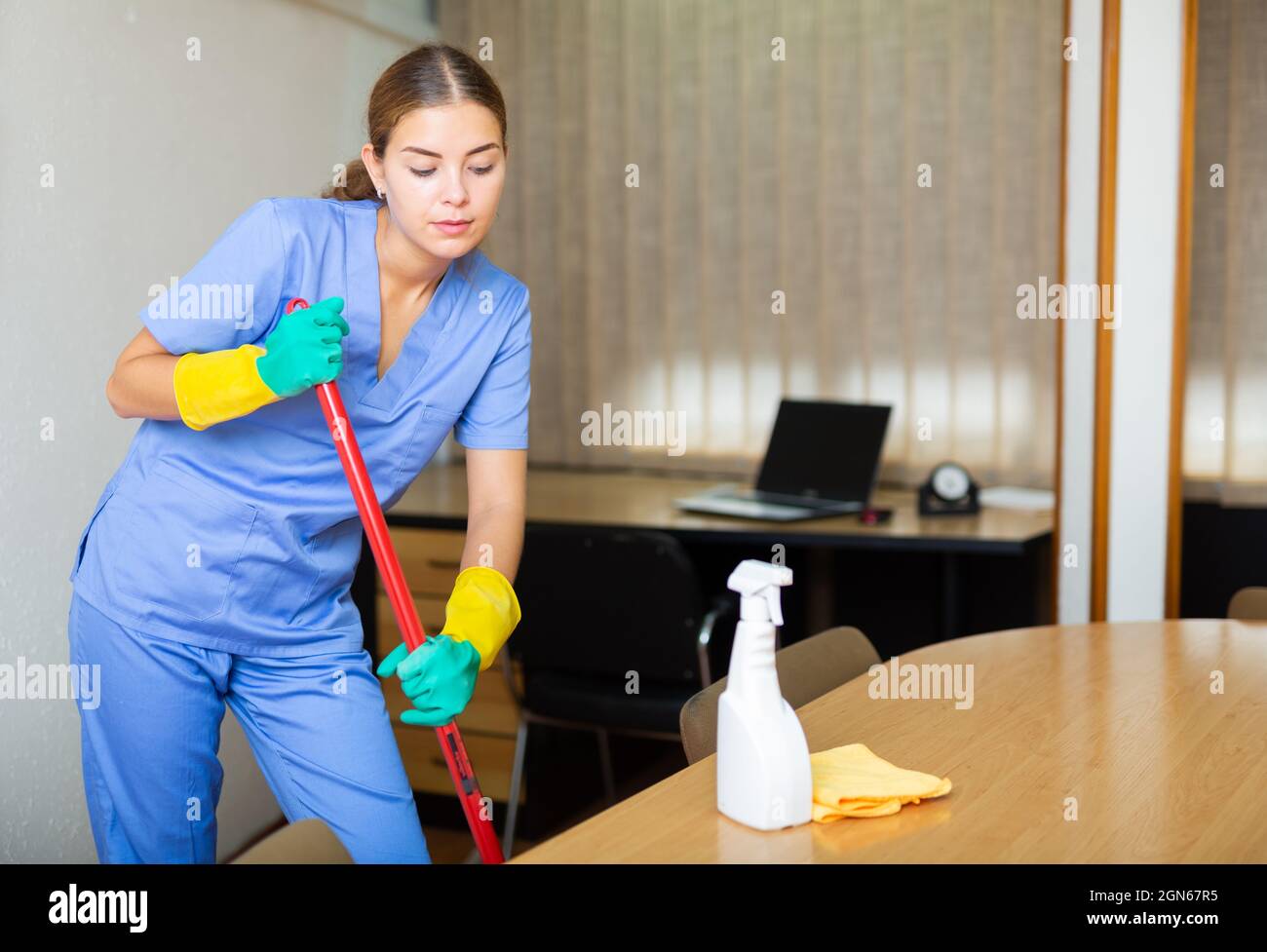 Female worker of office cleaning service wiping floors with mop Stock ...