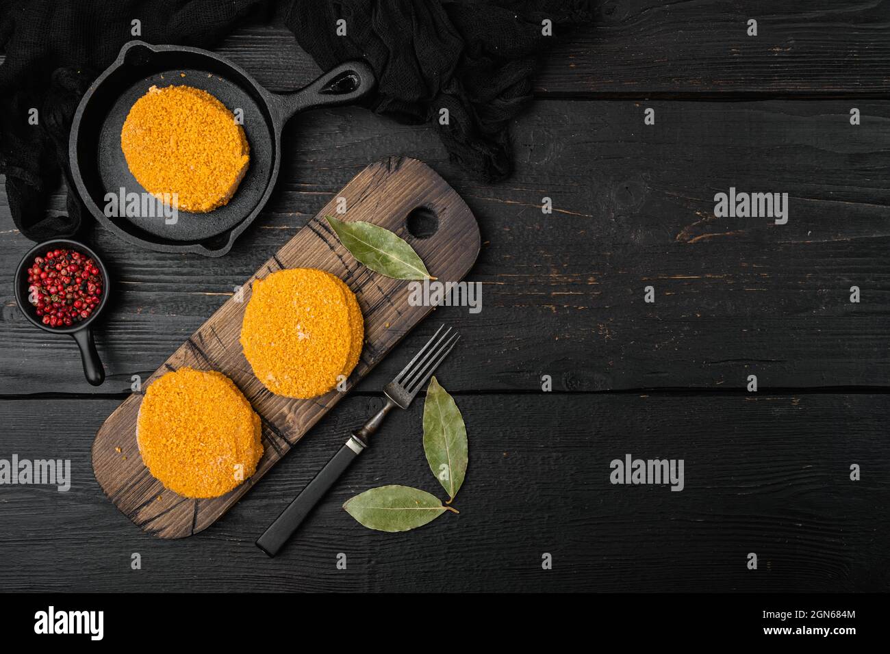Breaded fish patties set, on black wooden table background, top view ...