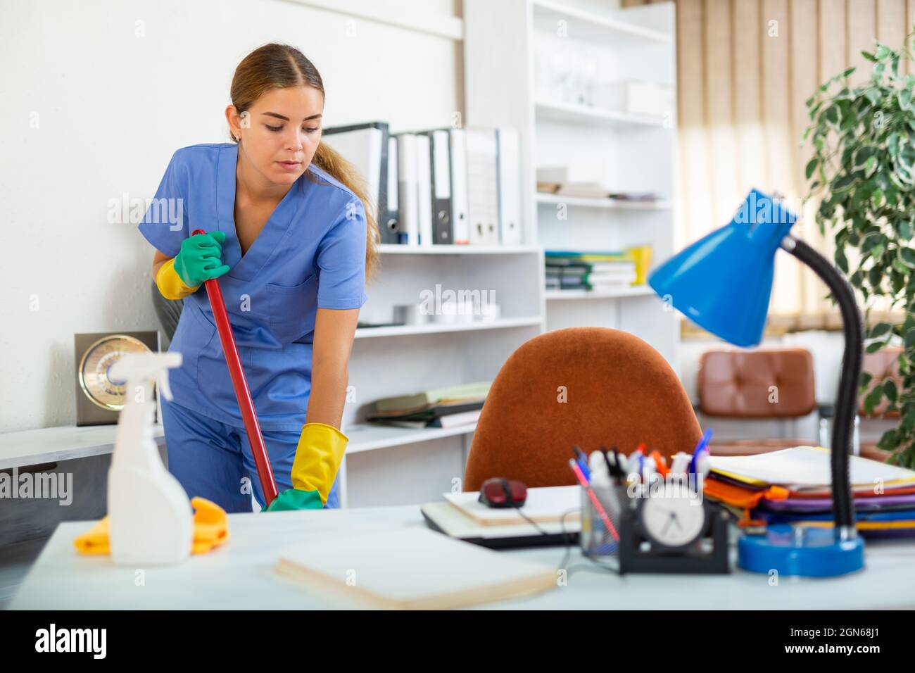 Female worker of office cleaning service wiping floors with mop Stock ...
