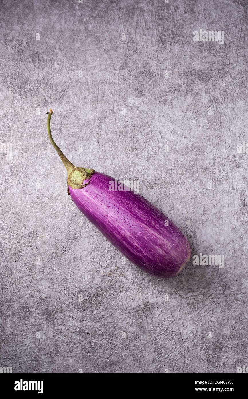 eggplant or brinjal, vegetable isolated on a textured background ...