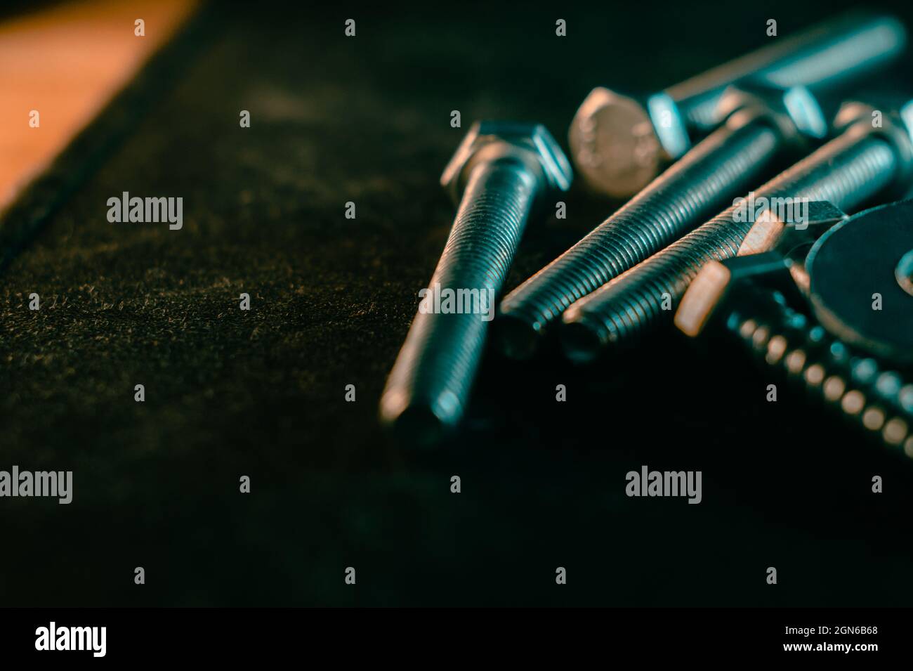 Closeup of the metal silver bolts on the black surface Stock Photo - Alamy