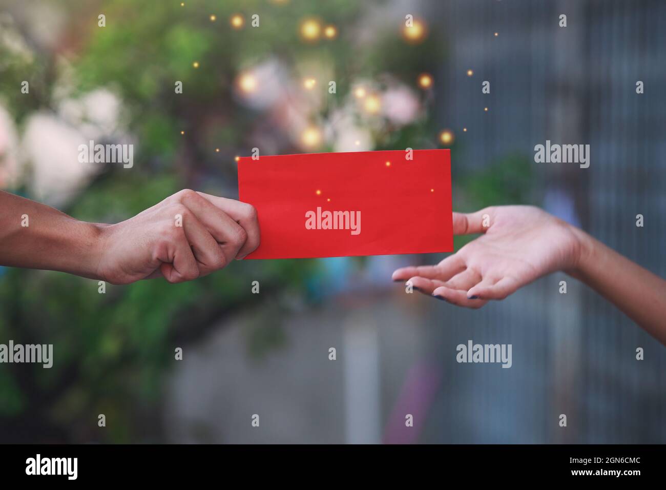 The elders hand give red envelope "Ang pao" to their children and ...