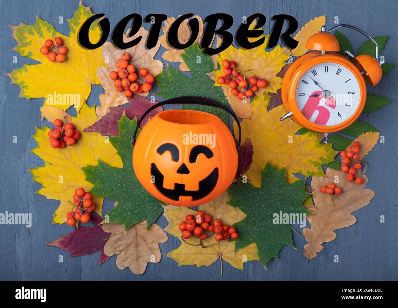 Pumpkin shape with a scary Jack o Lantern smile, orange alarm clock and ...