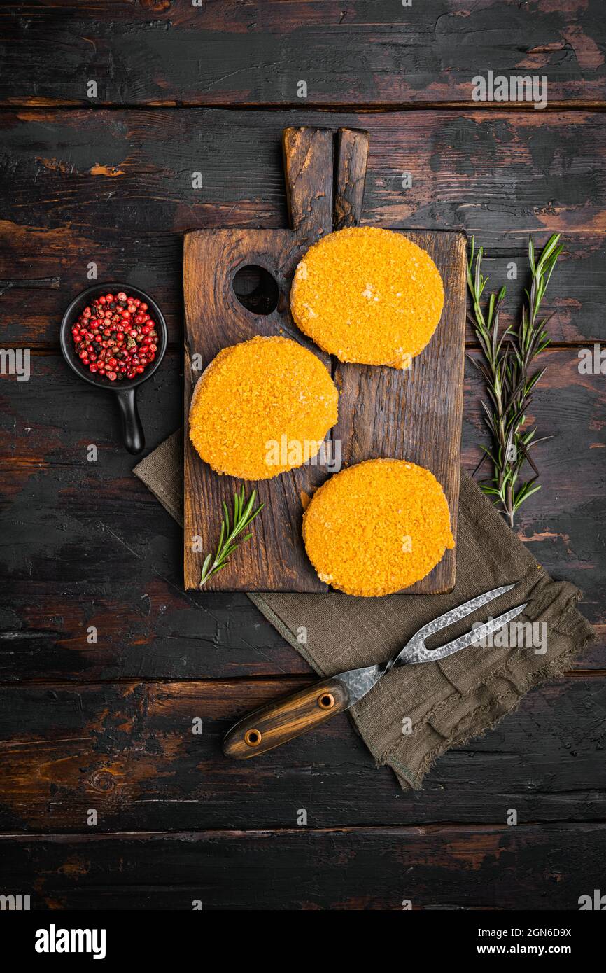 Raw fish patties set, on old dark wooden table background, top view ...