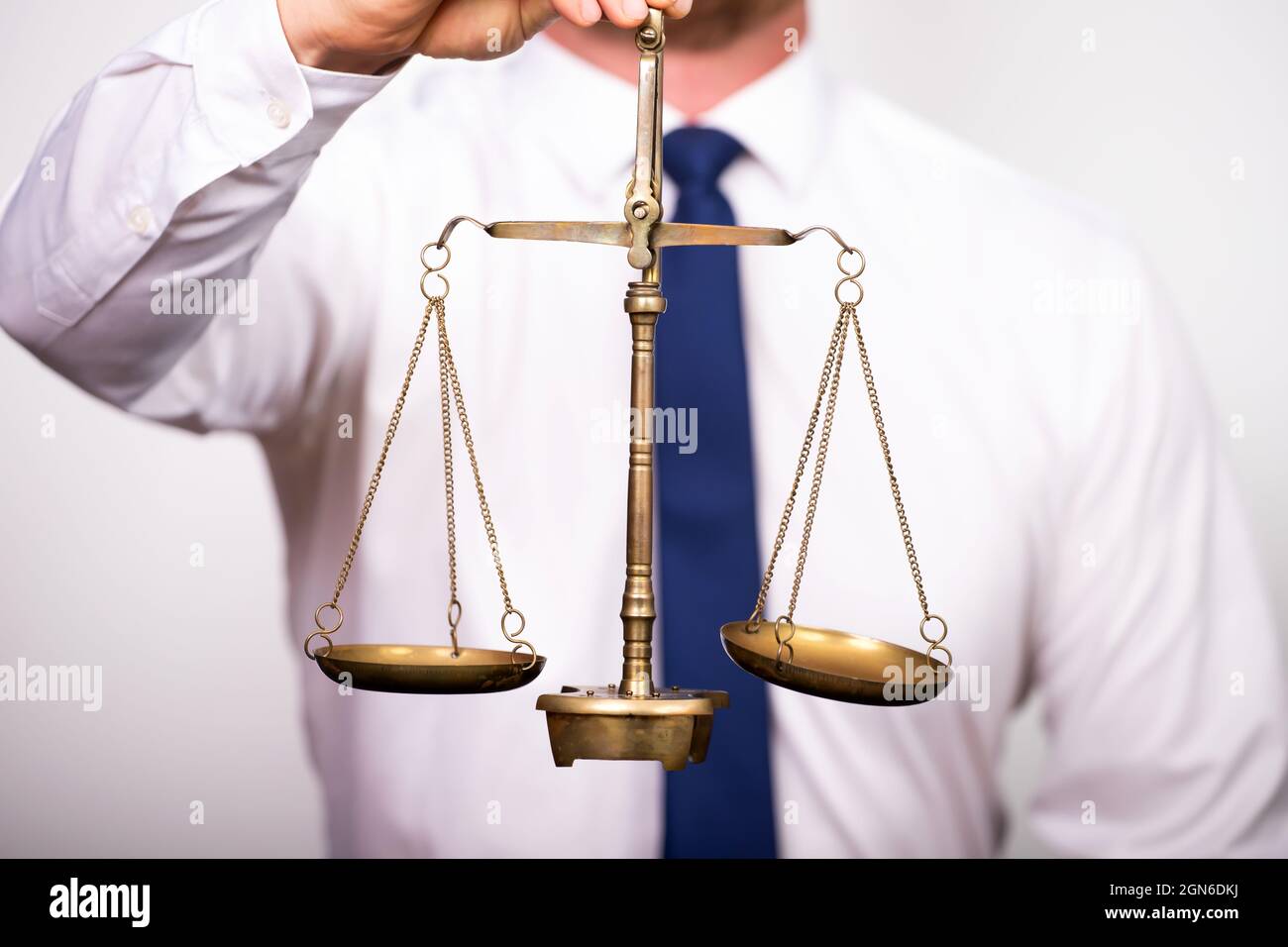 Weight scale of justice, lawyer in background. Justice, law, attorney ...