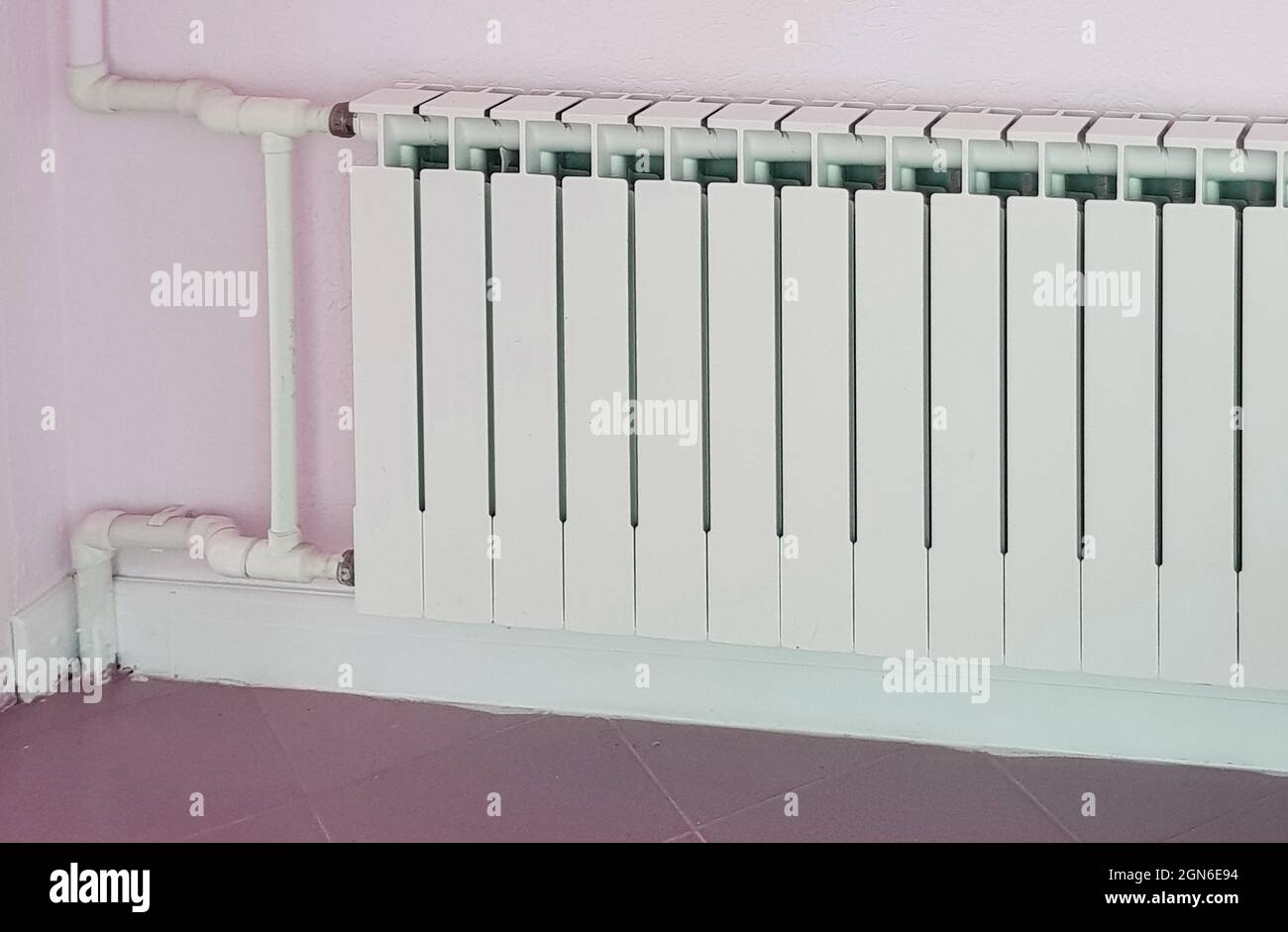 Modern aluminum white heating radiator on the background of a wall in a ...