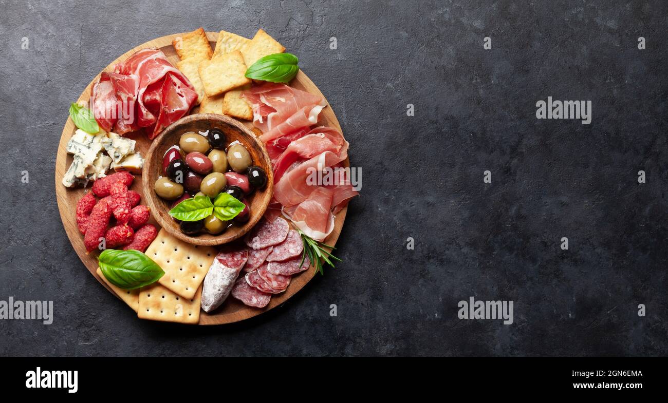Antipasto board with prosciutto, salami, crackers, cheese and olives ...