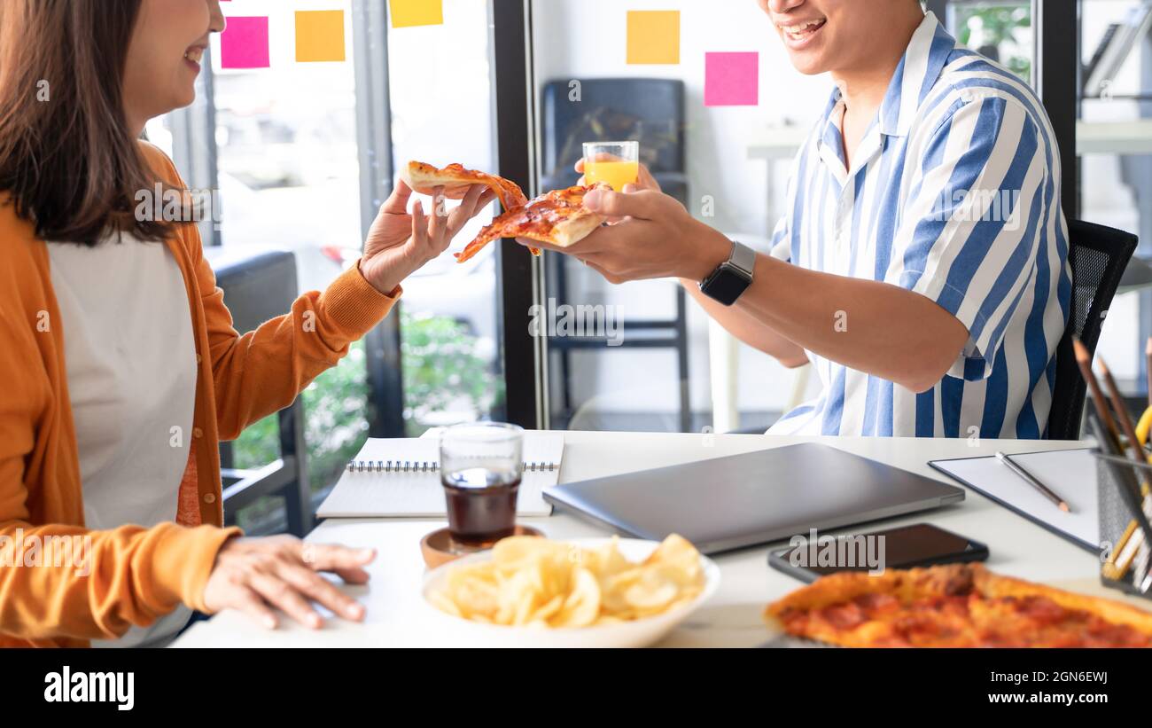 two happy officers enjoying eating pizzas chips and juice as their ...