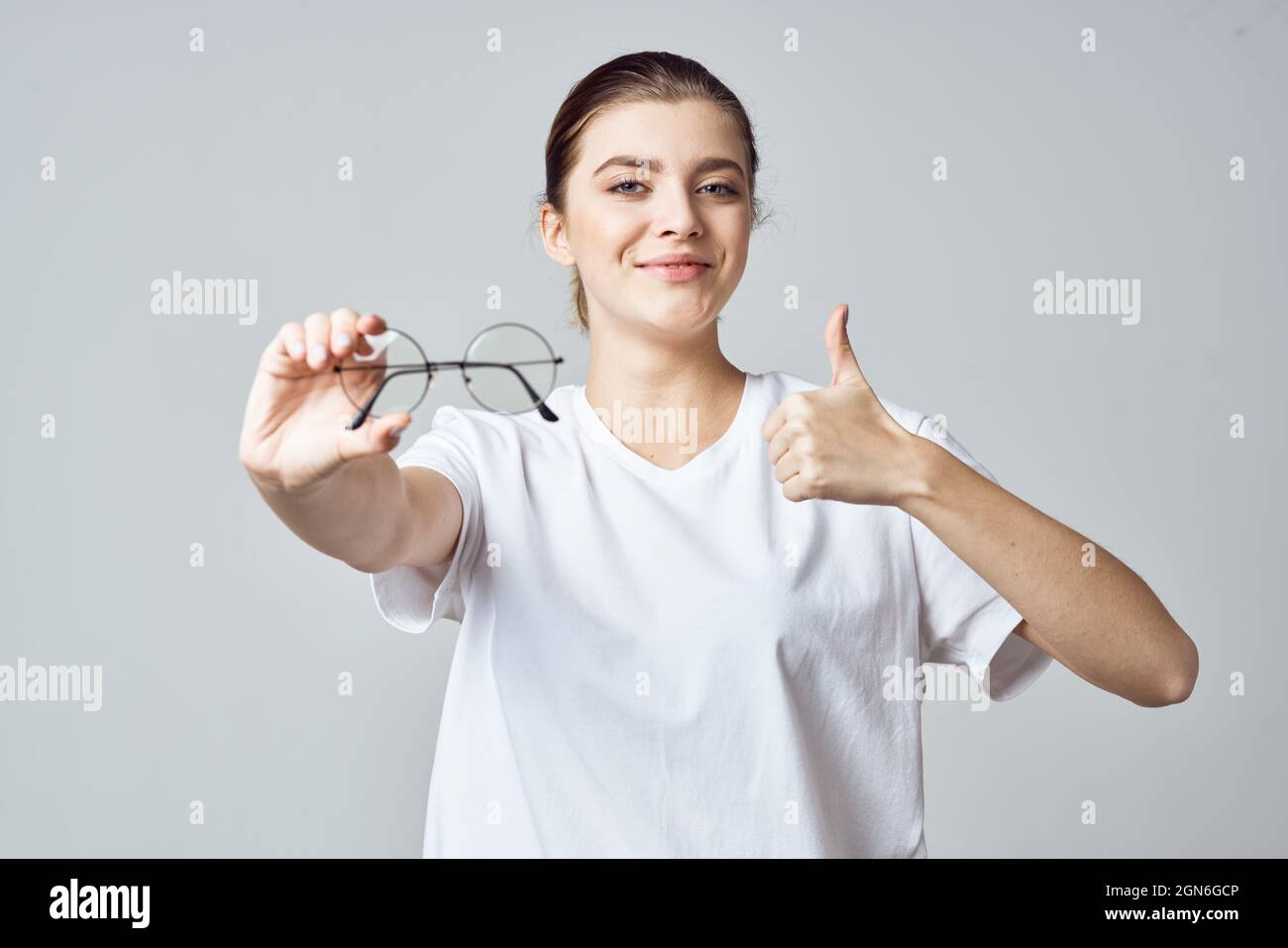 woman in white t-shirt glasses poor eyesight close-up Stock Photo - Alamy