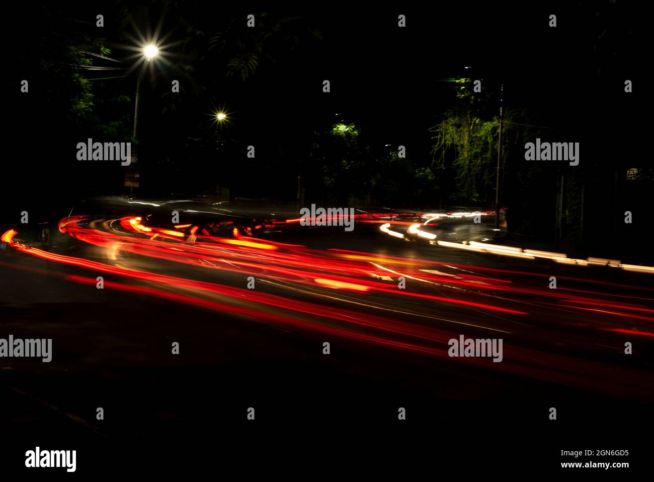 Car Light trails on a city street in a dark black night. Photo is taken ...