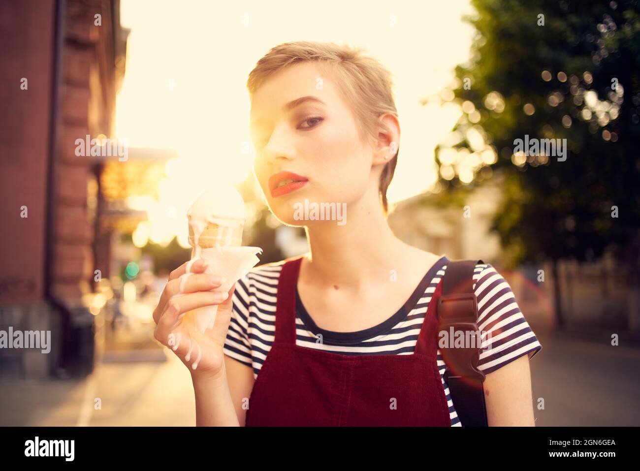 pretty woman outdoors eating ice cream walk Stock Photo - Alamy