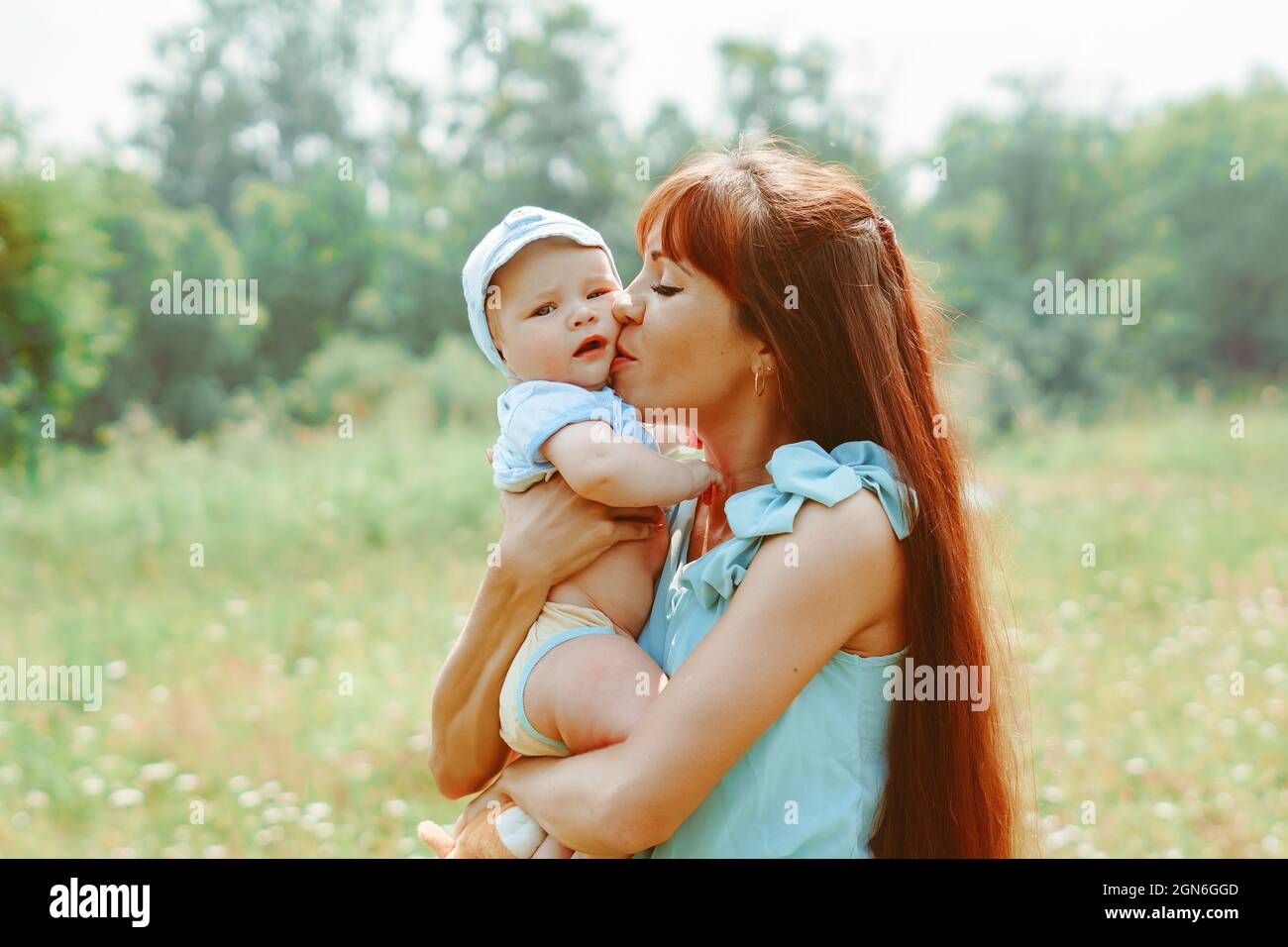 mother raises the child in her arms Stock Photo - Alamy