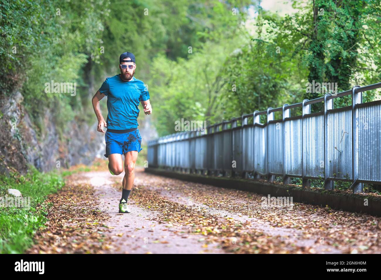 Man marathon runner during preparation on bike path Stock Photo - Alamy
