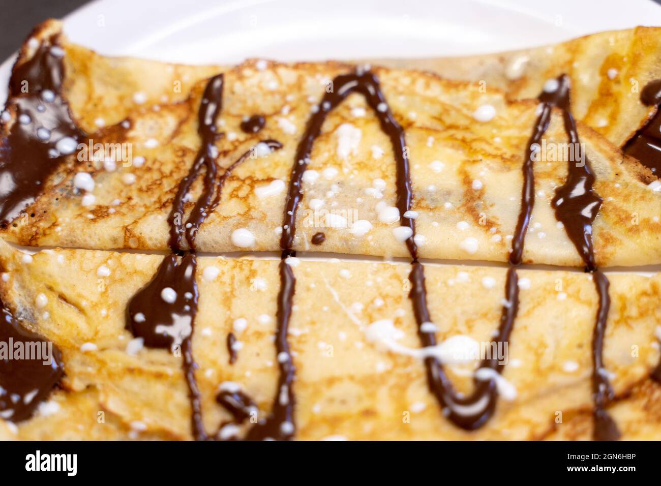 Aerial close up view of a pancake with chocolate on top served on a ...