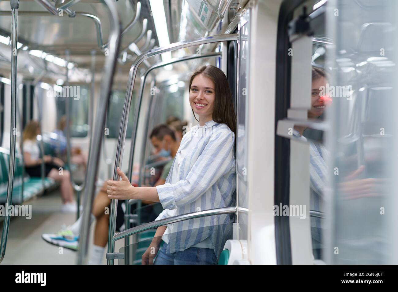 Happy young girl inside metro subway carriage student return home from ...