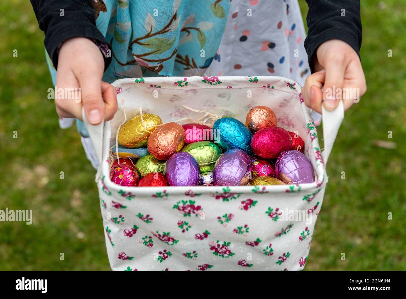 Little girl participating in an Easter egg hunt in a garden Stock Photo ...