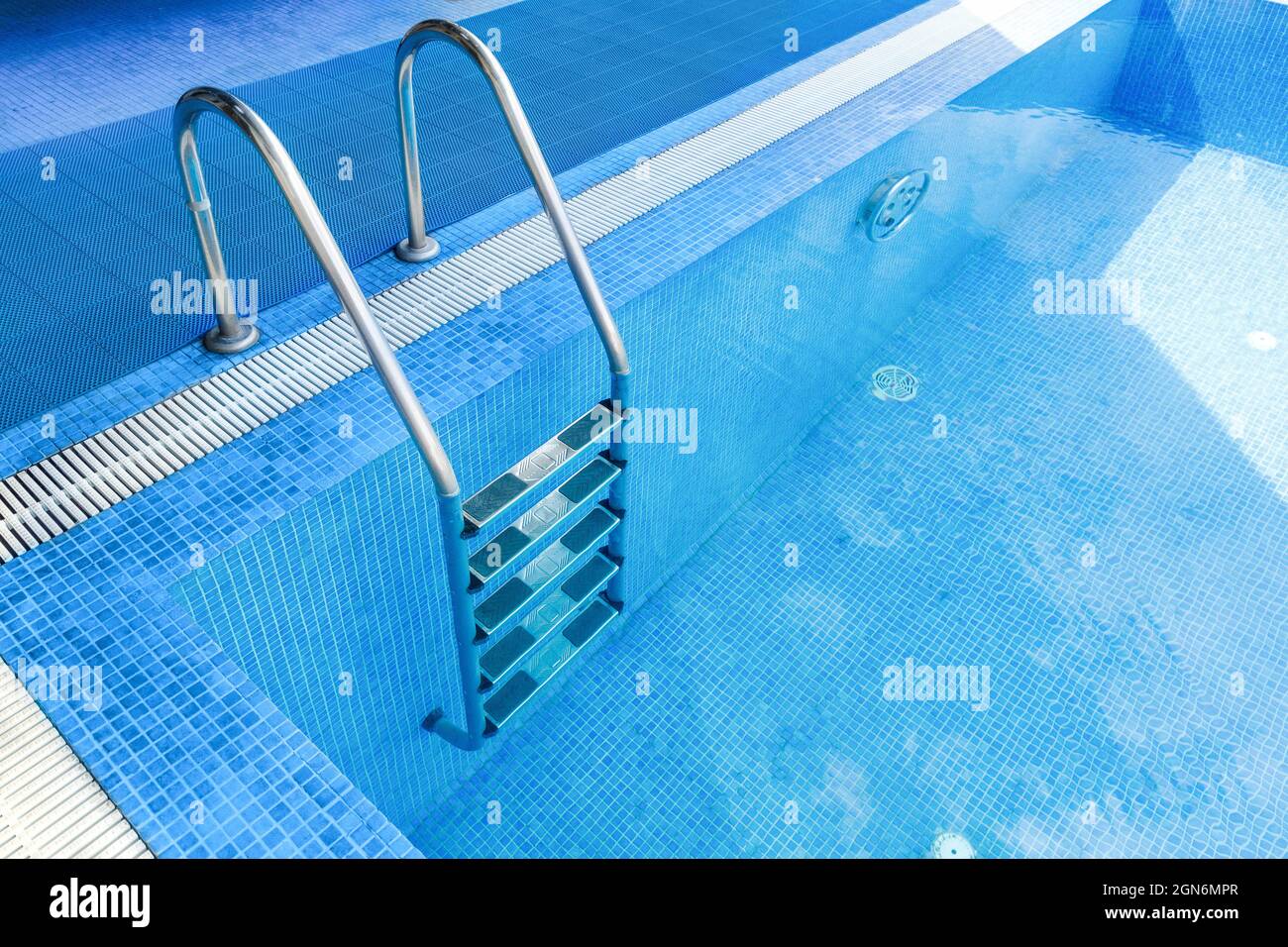 Side of the swimming pool with steel staircase and tiles Stock Photo ...