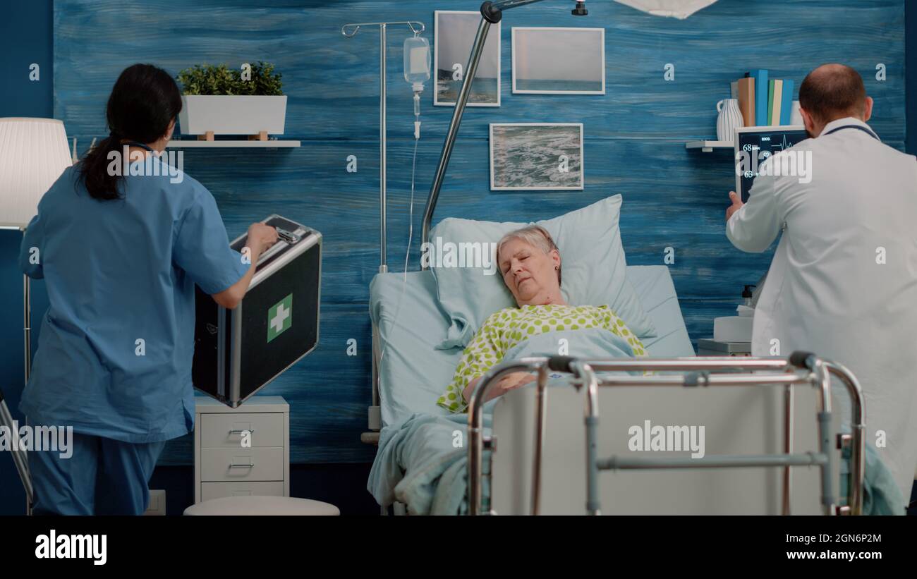 Medical team running with healthcare bags to help patient in hospital ...