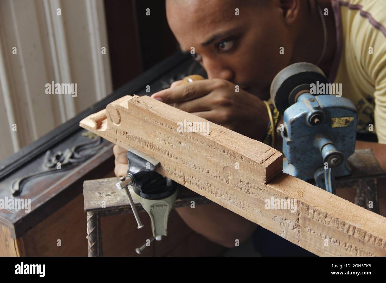 Man crafting wood planks indoors on a table Stock Photo - Alamy