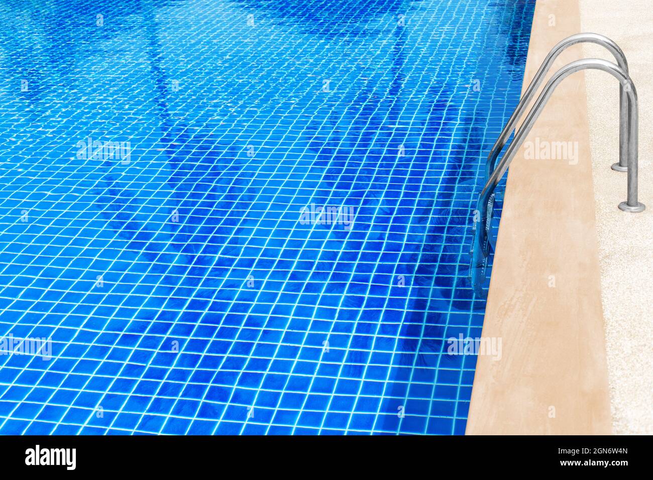 Swimming pool blue water, palm tree reflection, ladder, wooden deck ...
