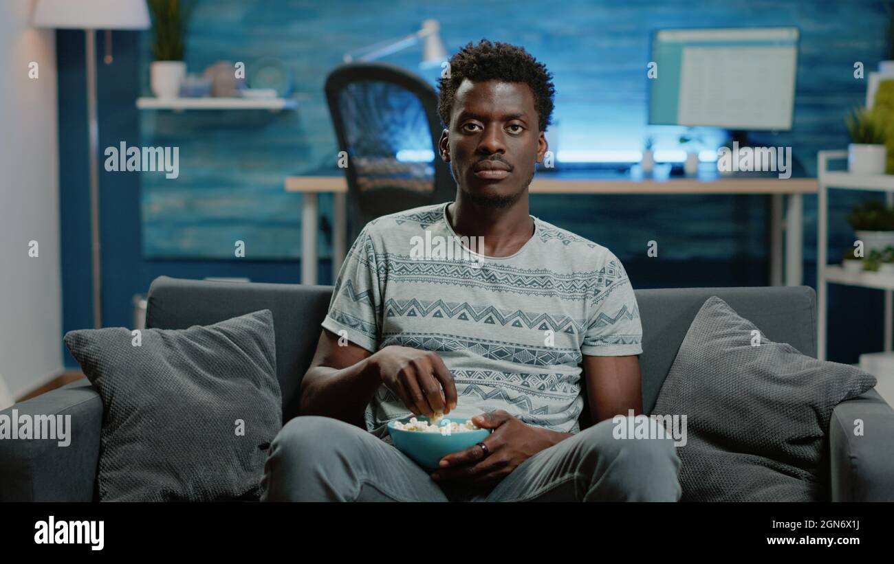 POV of person watching football game on television at home. Adult ...