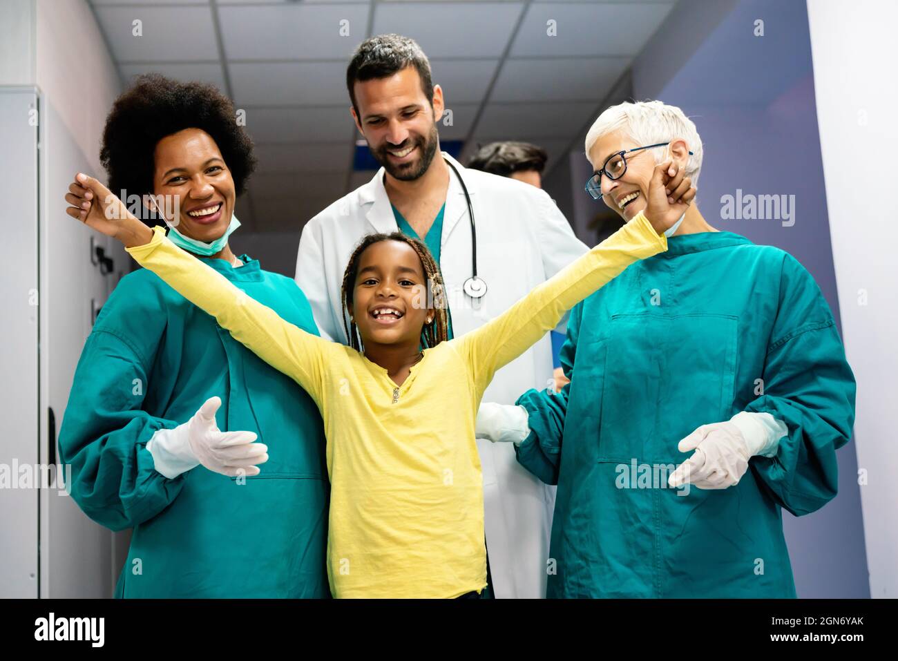 Team of experienced highly qualified doctors with child patient after a ...