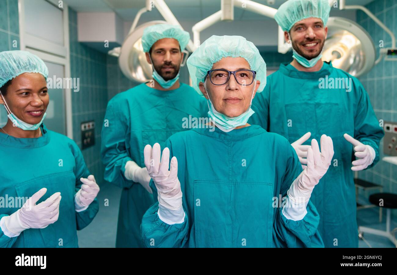 Successful team of surgeon standing in operating room, ready to work on ...