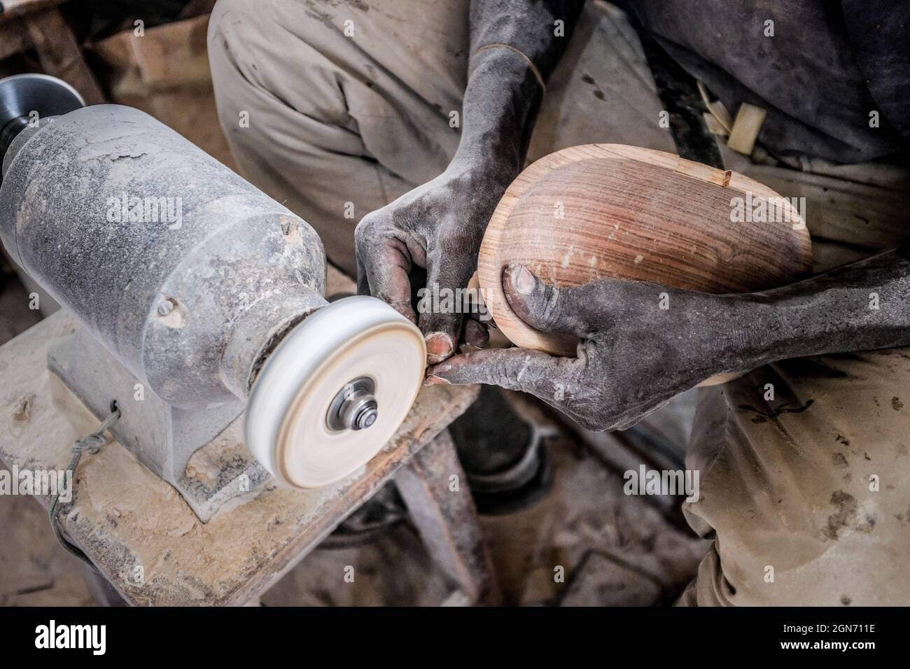 Robert Otieno (35) repairs his handmade bowls designed with recycled ...