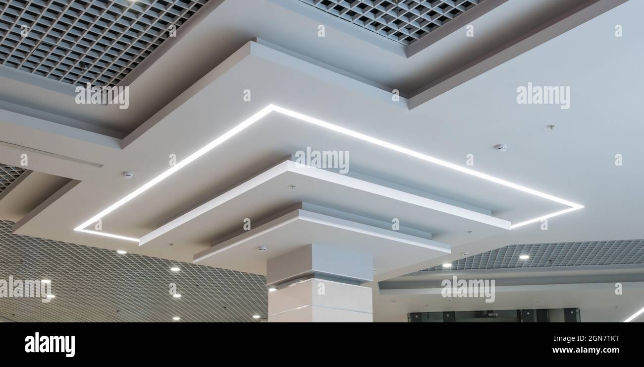 column in interior with suspended and grid ceiling with halogen spots ...