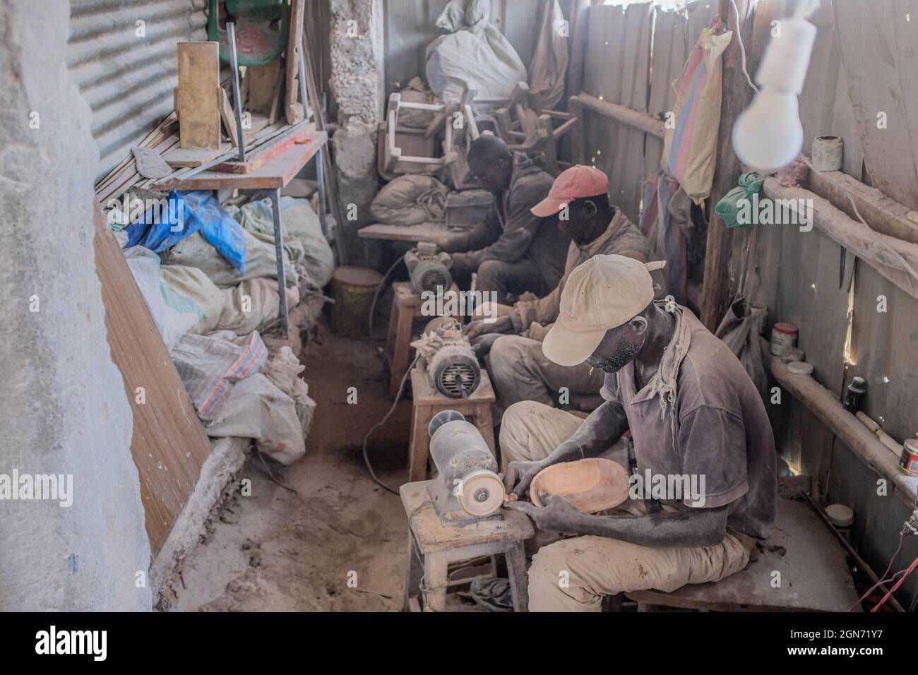 Workers from The African Bone Craftwork together at their workshop in ...