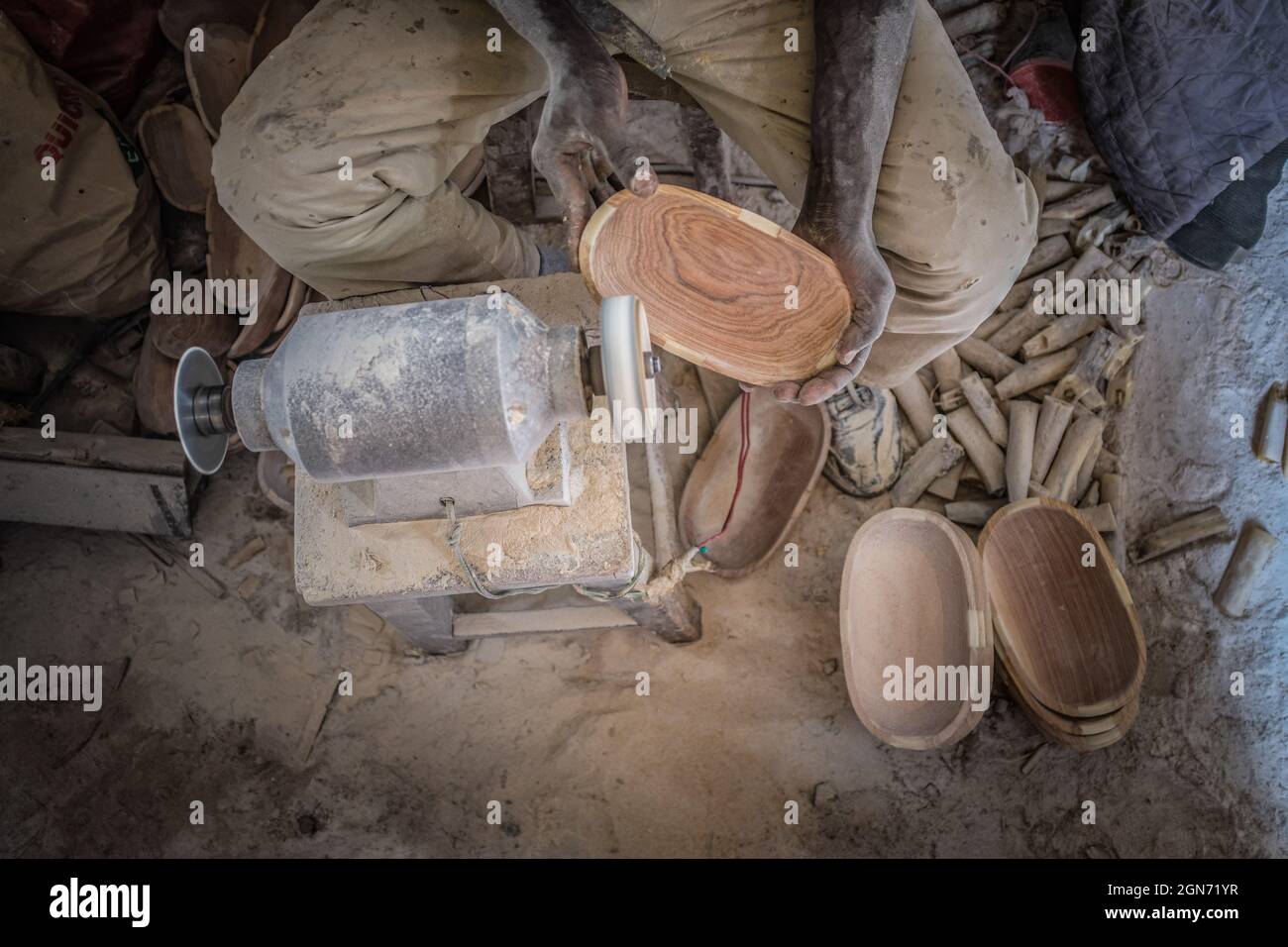 Robert Otieno (35) repairs his handmade bowls designed with recycled ...