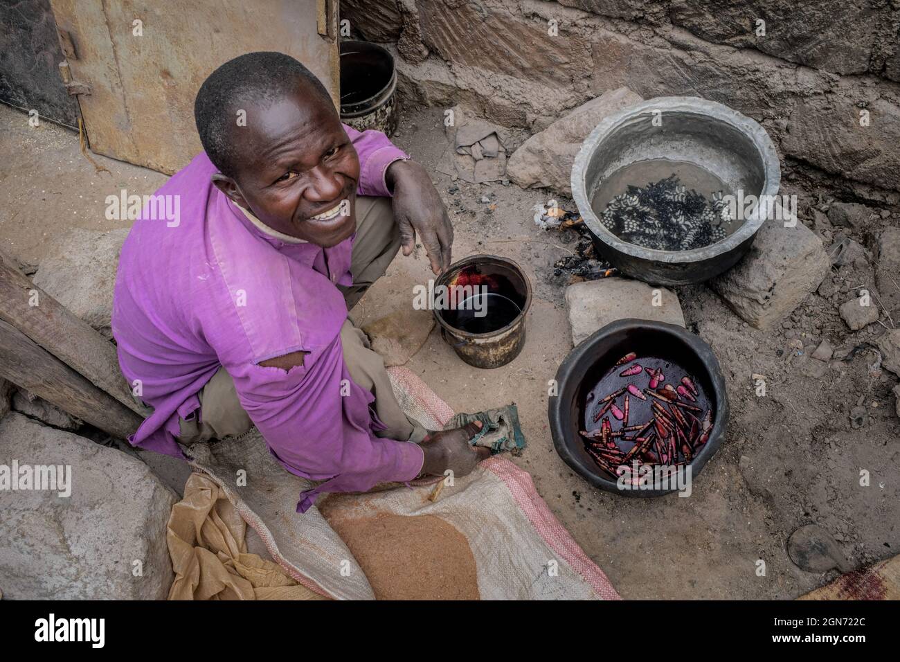 A worker at the African Bone Craft prepares to designs final bone craft ...