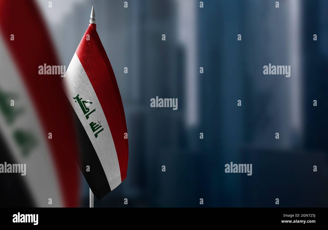 Small flags of Iraq on a blurry background of the city Stock Photo - Alamy