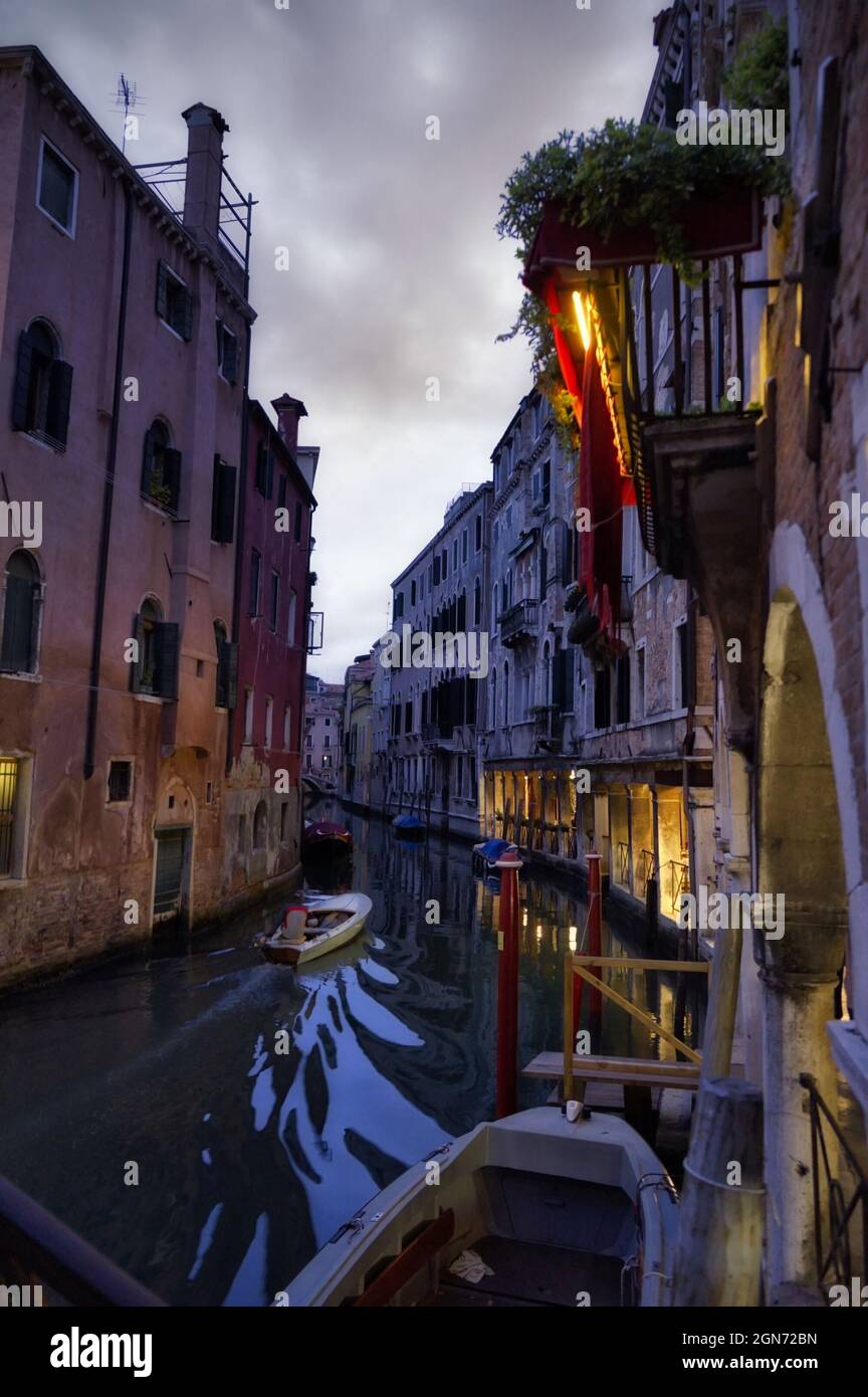 Vertical shot of a canal in Venice, Italy during an evening Stock Photo ...